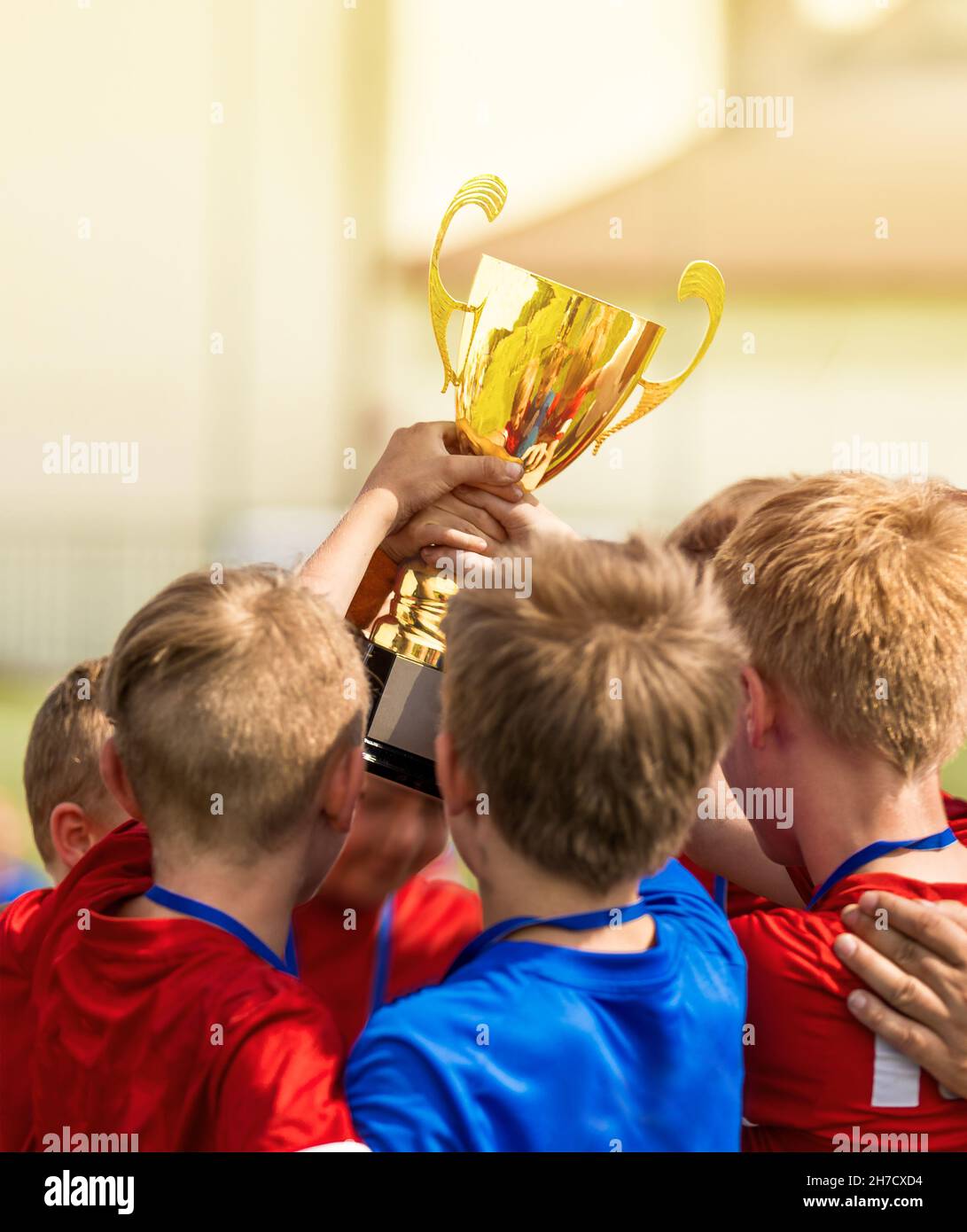 Group of Happy Boys in Red and Blue Sports T-shirts Pick Up the Golden ...