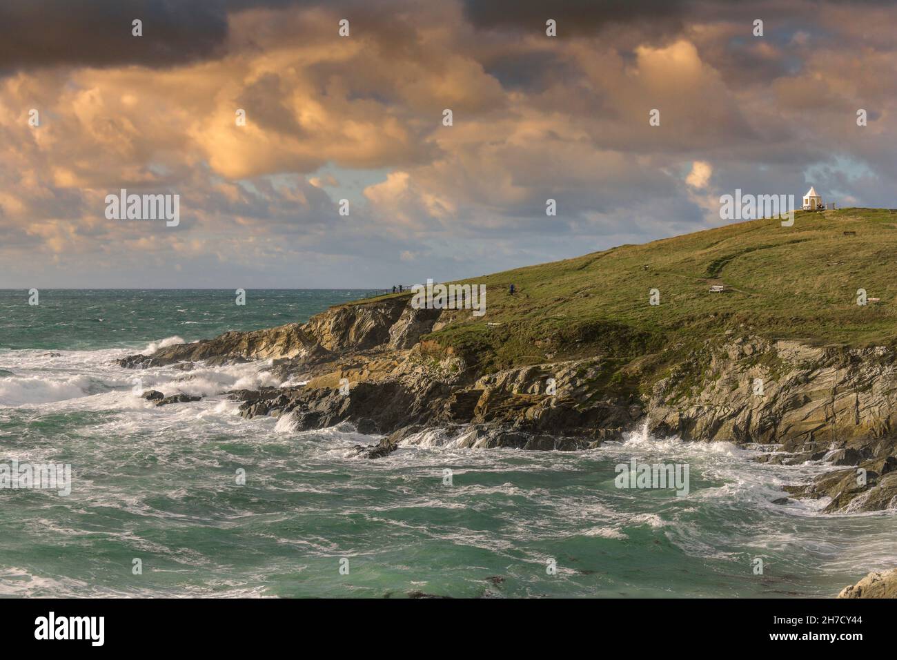 Late afternoon sunlight over high tide at Towan Head in Newquay in ...