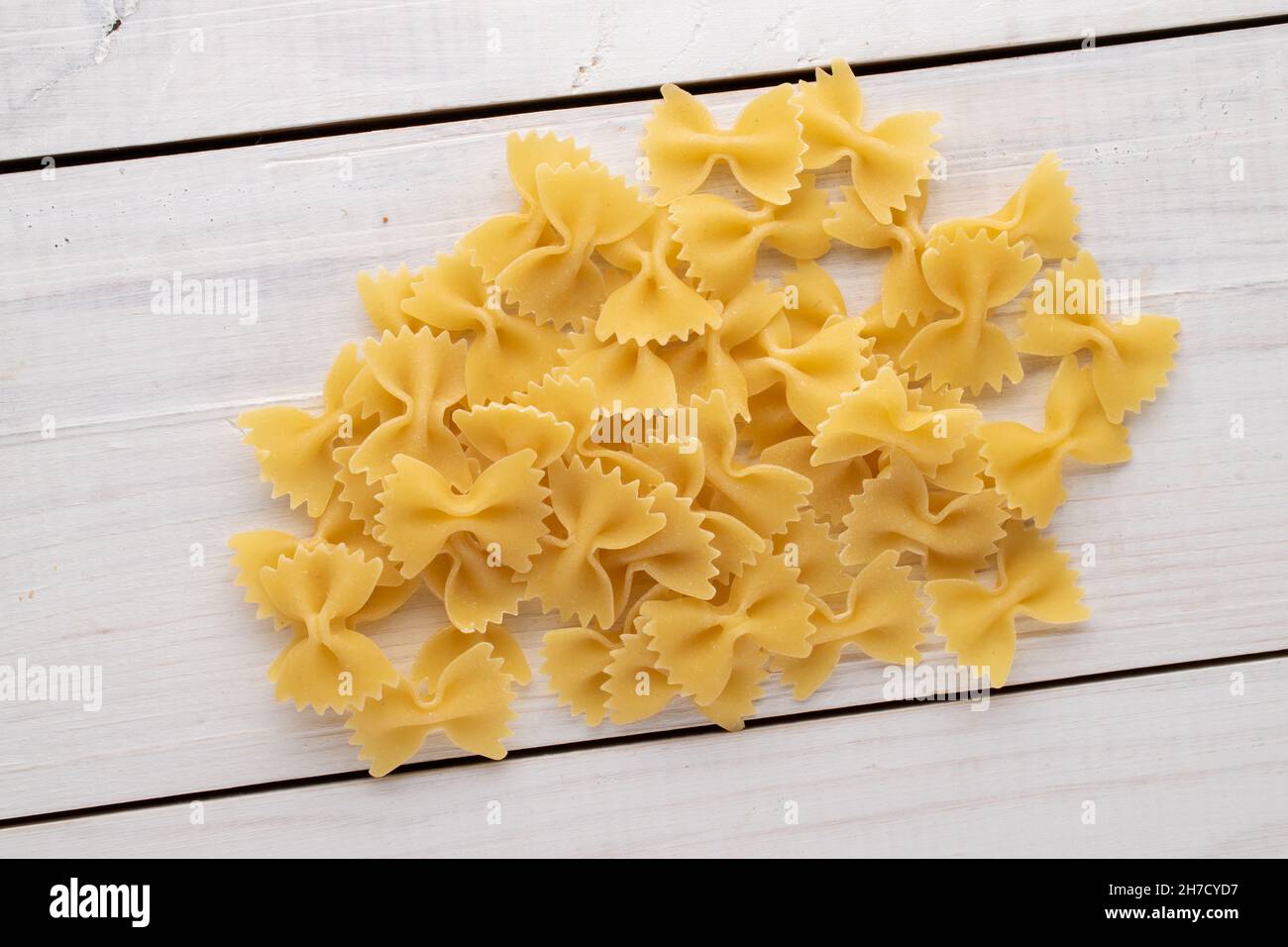 Light yellow pasta "Butterflies", close-up, on a wooden table, top view ...