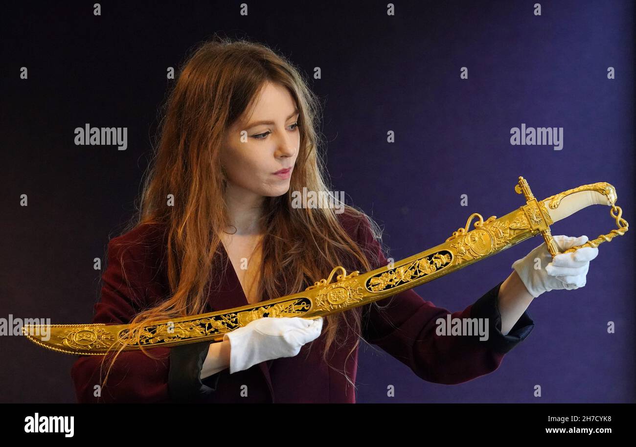 A Bonhams employee displays the Lloyd's Patriotic Fund Trafalgar Sword ...
