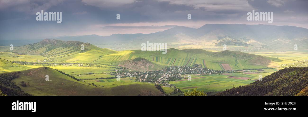 Panoramic view of a distant village in a rural area with a sown ...