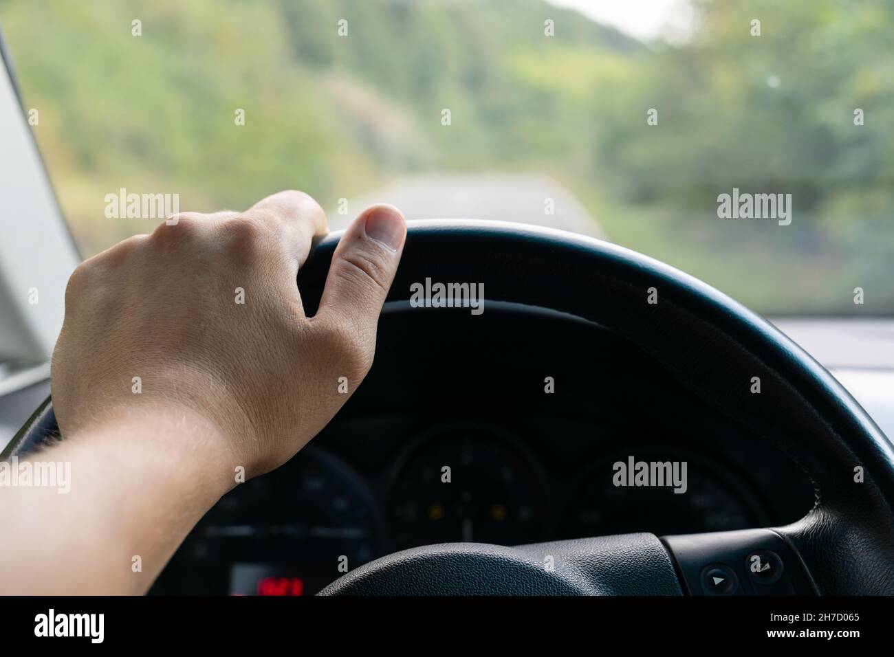 Man driving a car with one hand on a steering wheel Stock Photo - Alamy