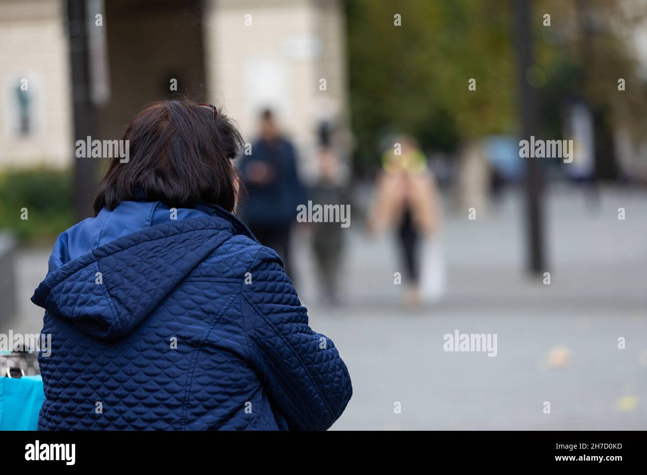 Photo of unrecognizable person sitting on an urban bench Stock Photo ...