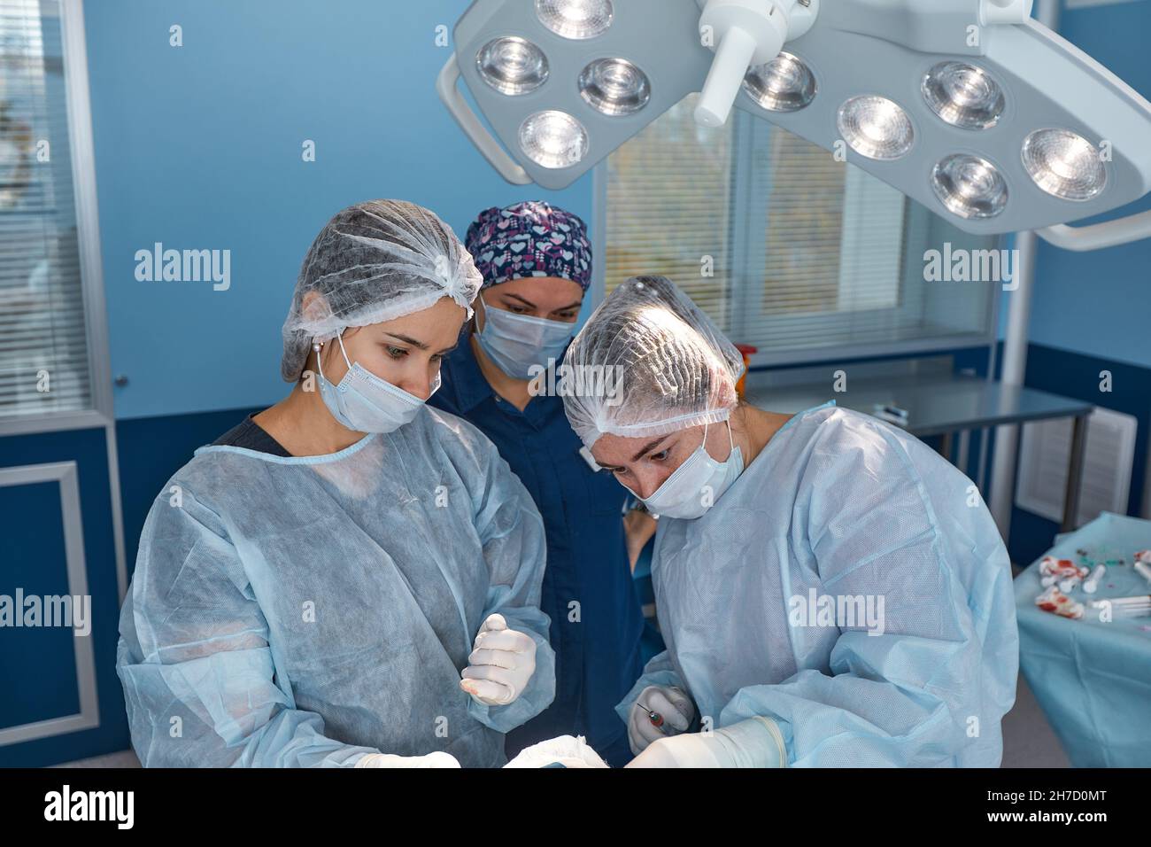 Concentrated Surgical team operating a patient in an operation theater ...