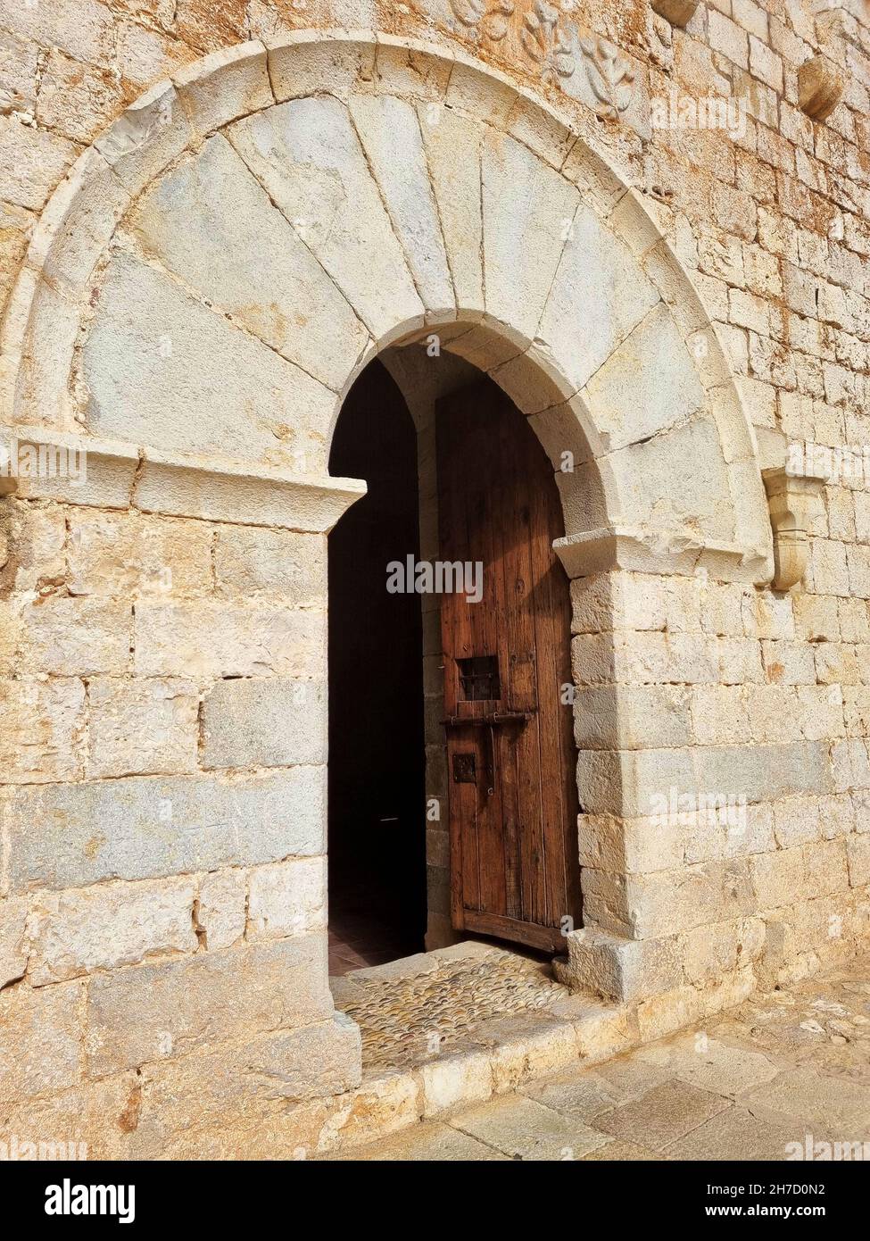 Vertical shot of an ancient door opening shot of a castle in Spain ...