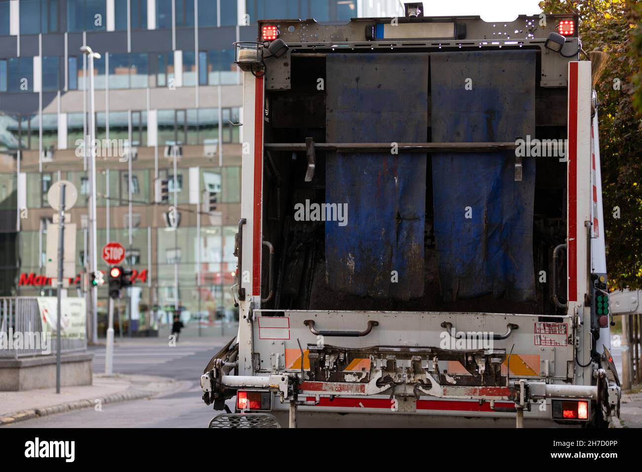 Picture of a garbage truck collecting waste in a big city Stock Photo ...
