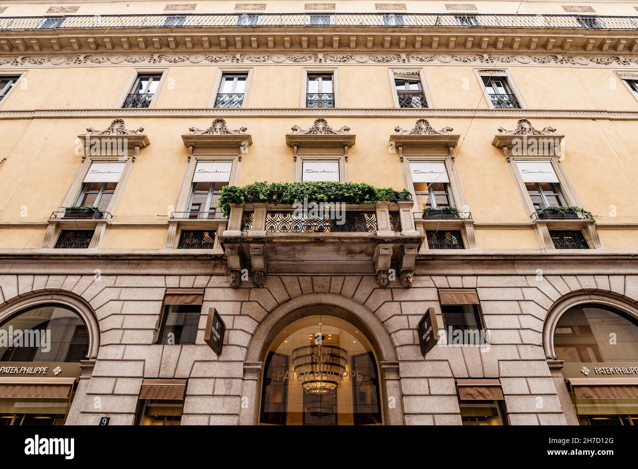 Facade of an old building with arches and stucco. Milan, Italy Stock ...