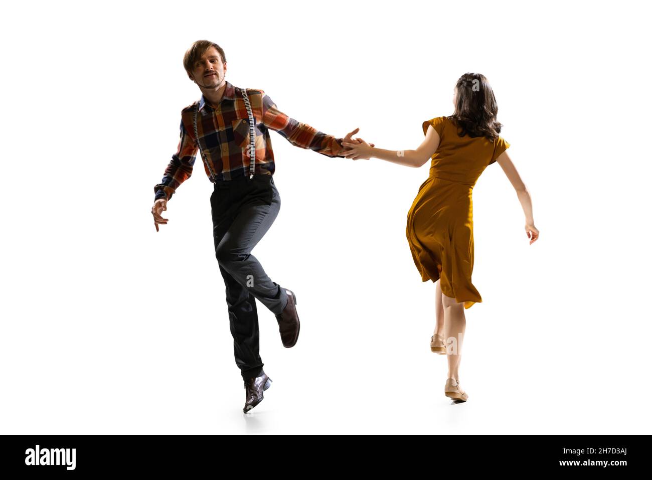 Two dancers, young man and woman in old-school fashioned attire dancing ...