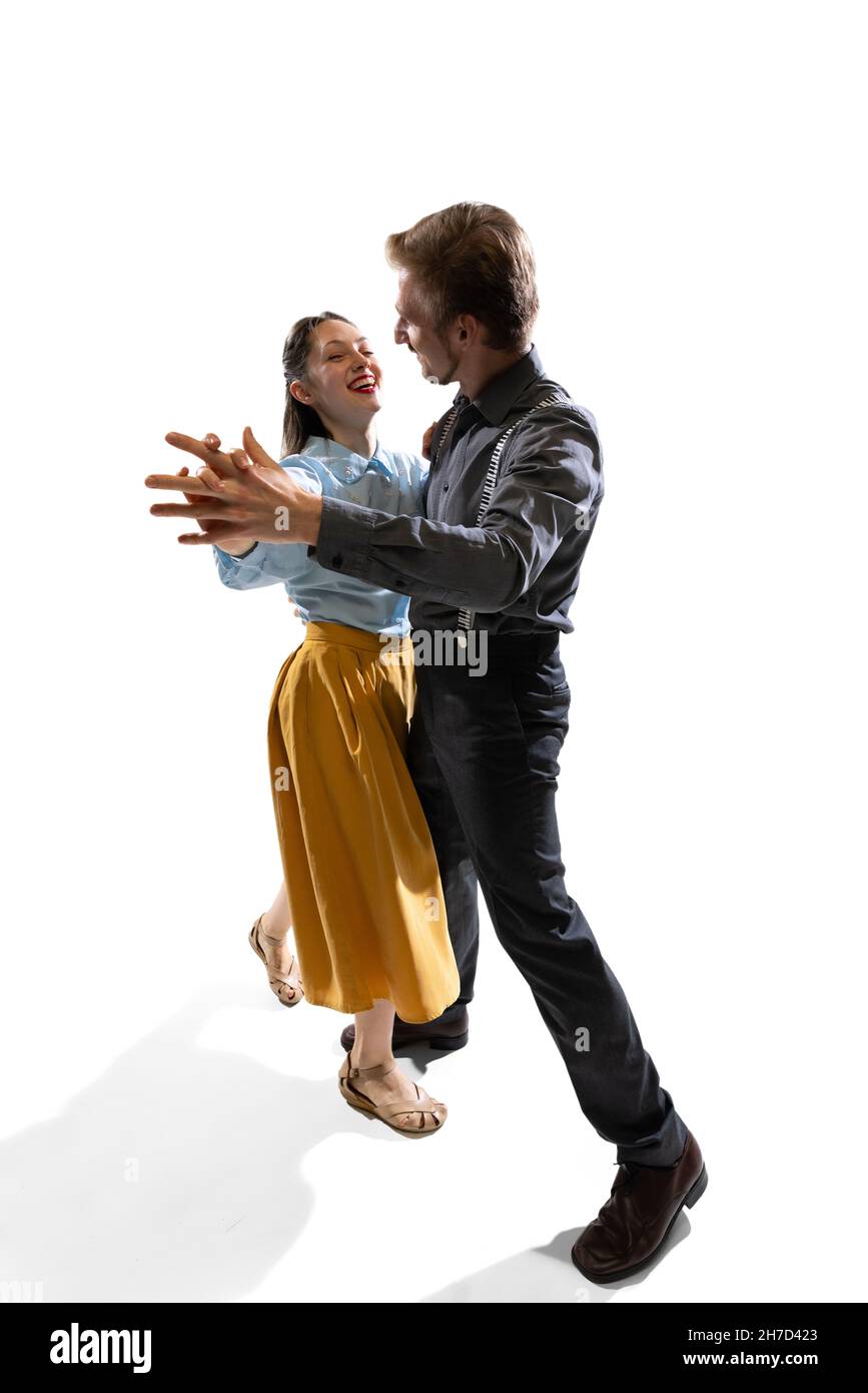 Close-up two people, young man and woman in vintage attire dancing ...