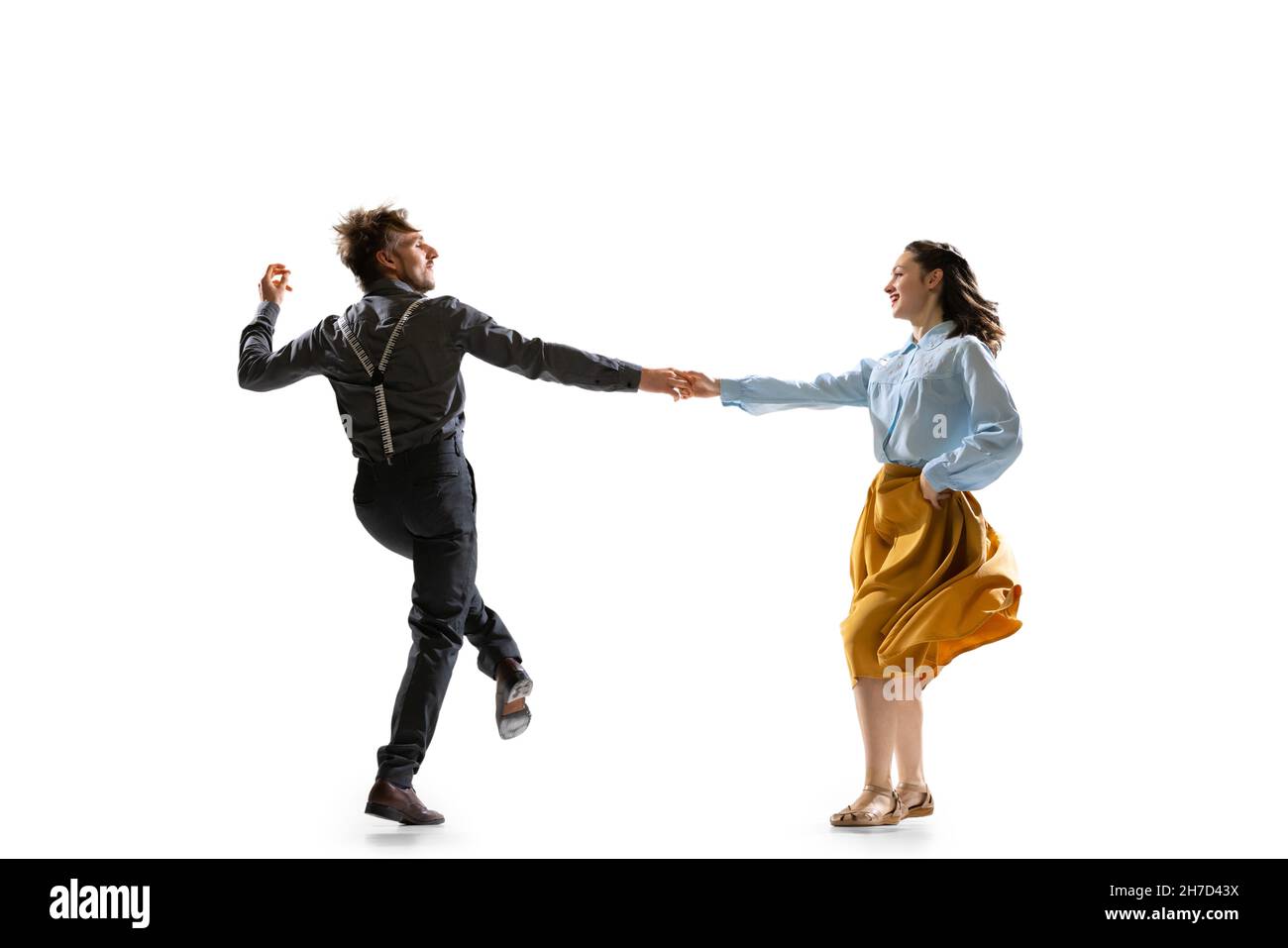 Two dancers, young man and woman in old-school fashioned attire dancing ...