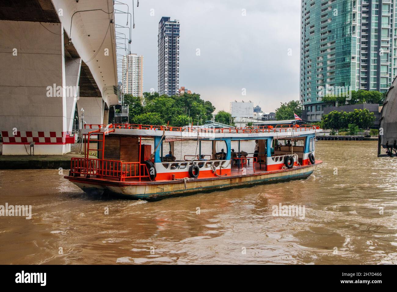 a ferry boat cross the Chao Phraya River at the Sathorn Pier in Bangkok ...