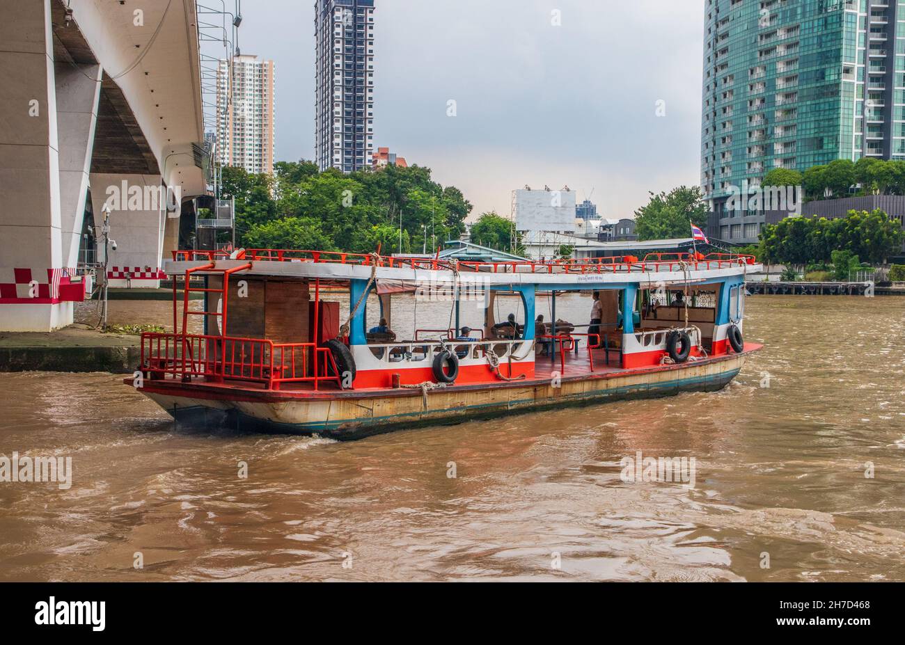 a ferry boat cross the Chao Phraya River at the Sathorn Pier in Bangkok ...