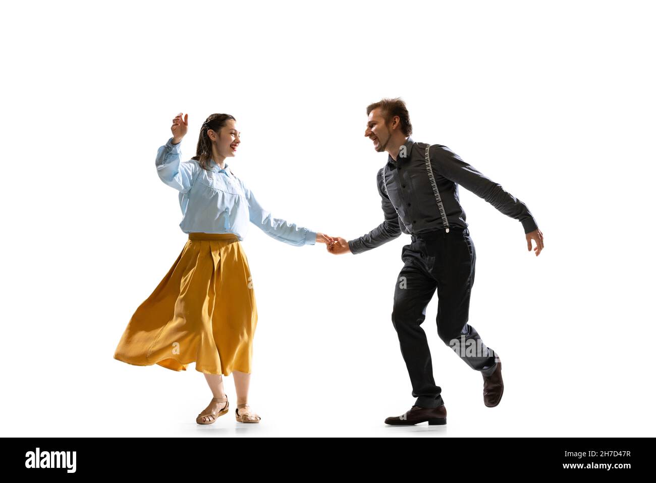 Two dancers, young man and woman in old-school fashioned attire dancing ...