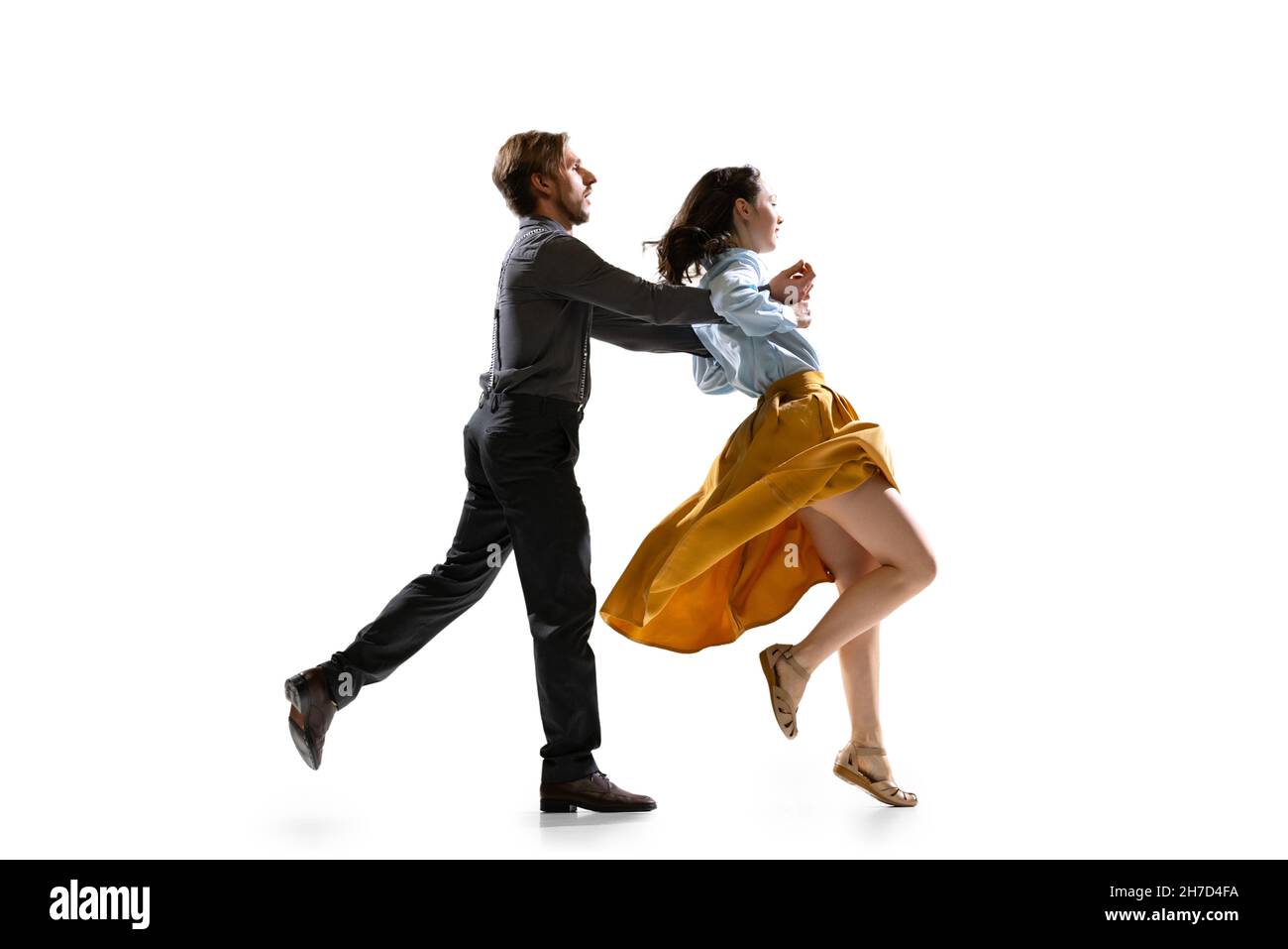 Two dancers, young man and woman in old-school fashioned attire dancing ...