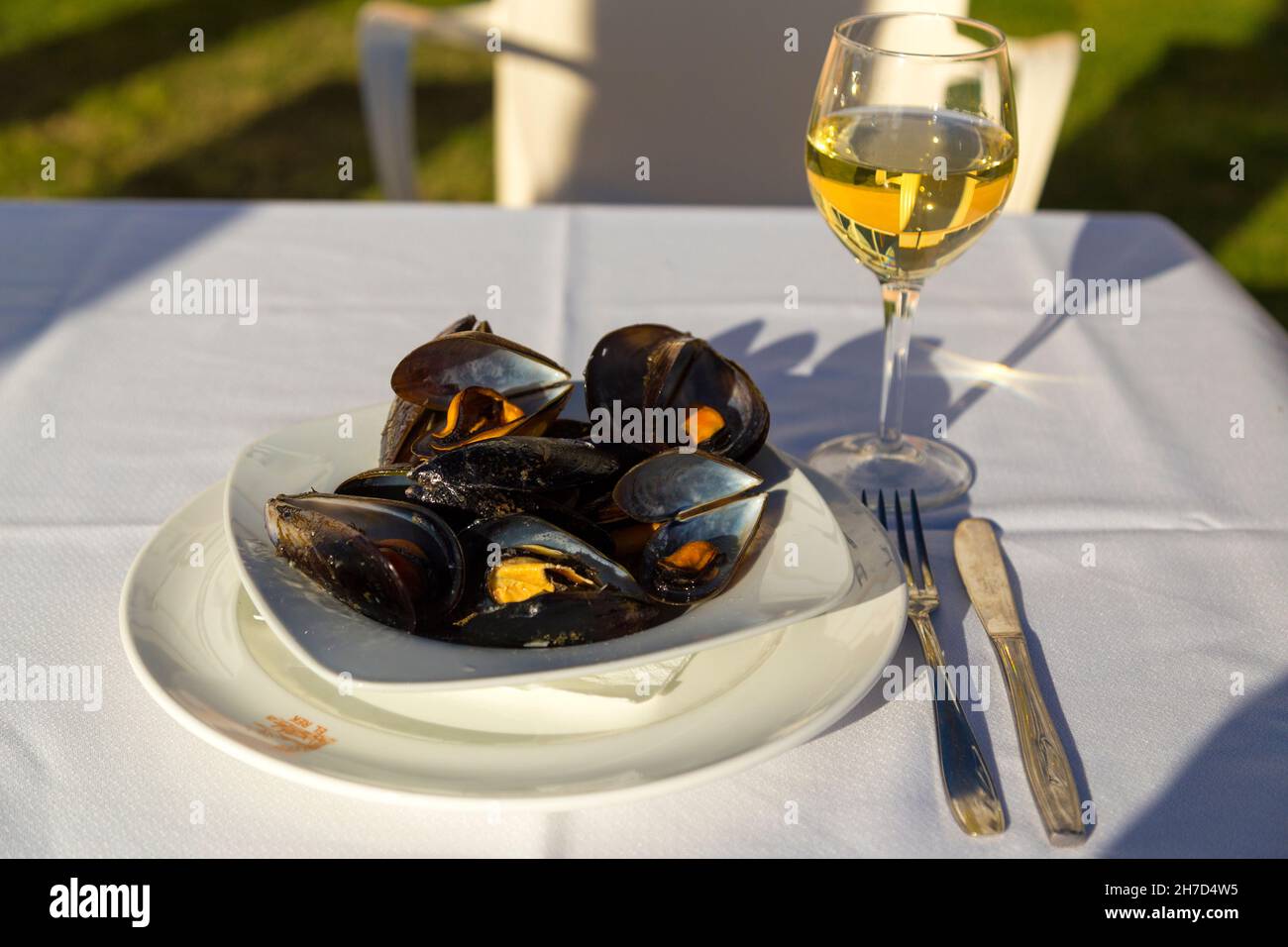 Spanish tapas, mussels steamed in white wine, on white tablecloth ...
