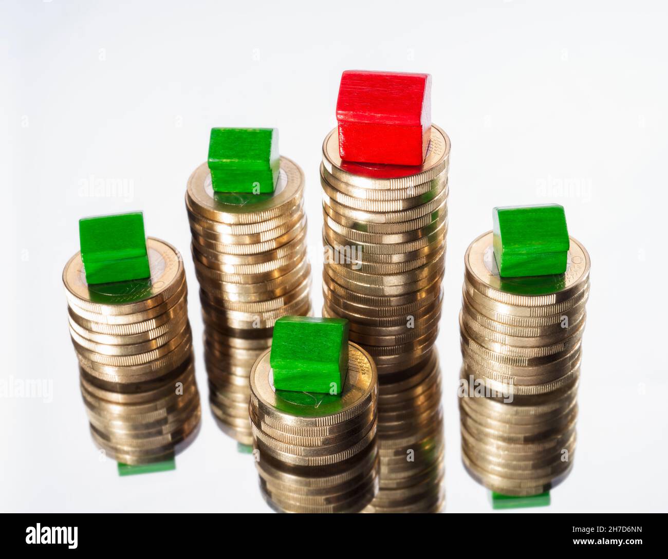 Houses on five stacks with coins Stock Photo - Alamy