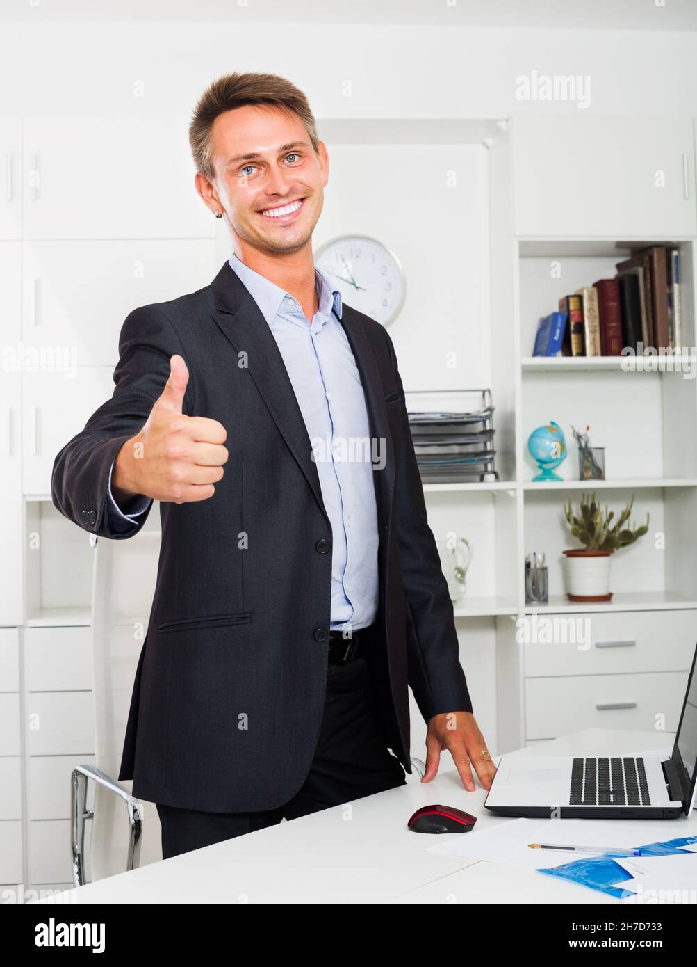 Business man standing with desk Stock Photo - Alamy