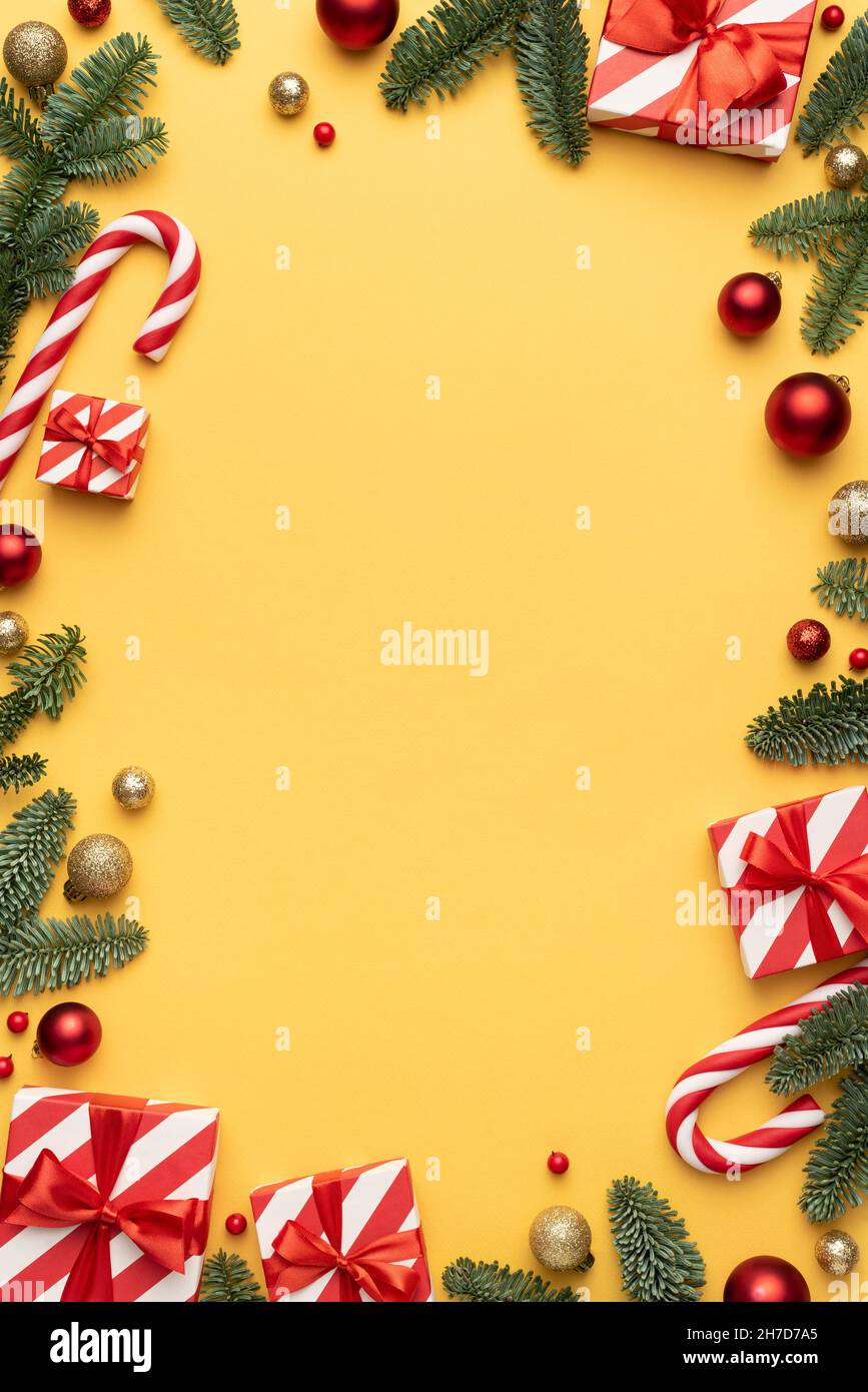 Yellow Christmas background with branches, boxes of gifts and Christmas ...