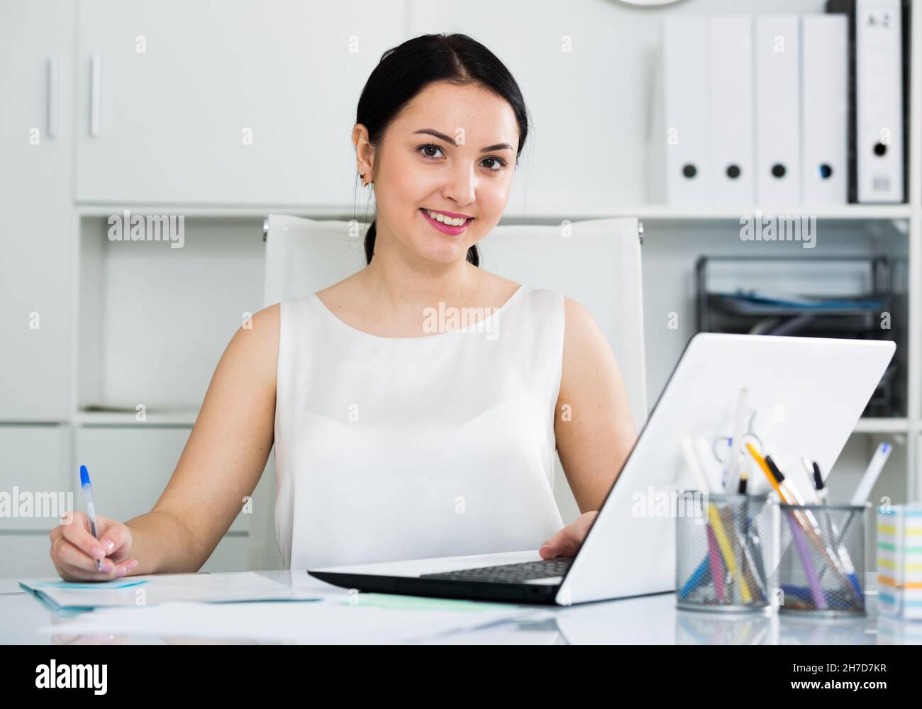 Woman working in office Stock Photo - Alamy