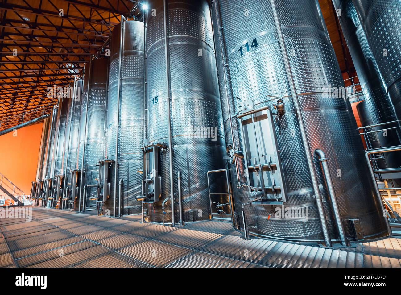 Large metal vats in which wine or beer is fermented at the factory at ...