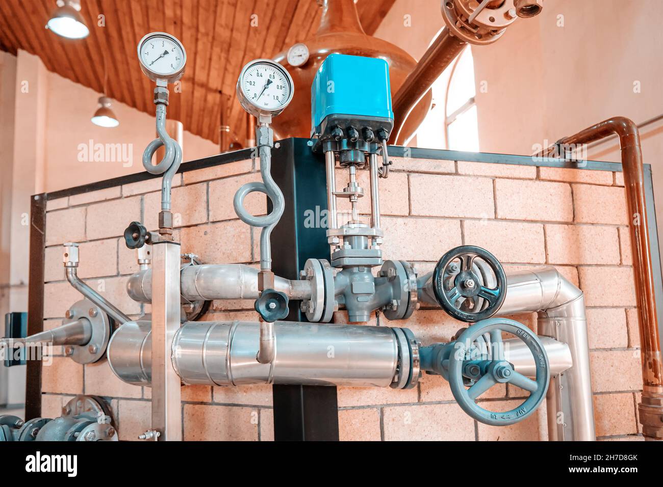 At the distillery plant of strong alcohol. Close-up of pipes with ...