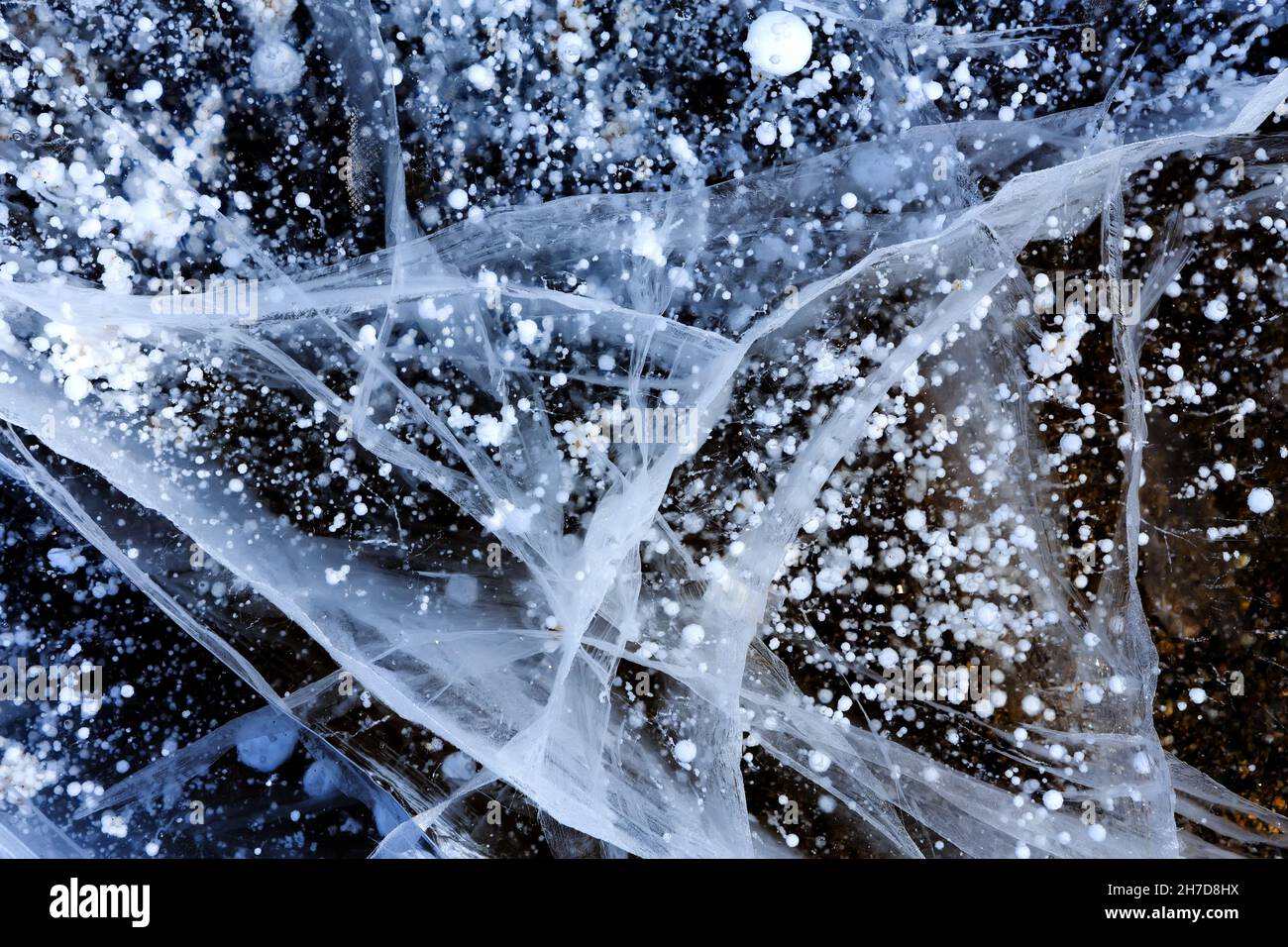 Methane bubbles in the Baikal ice. Cracks on the surface of lake. Top ...