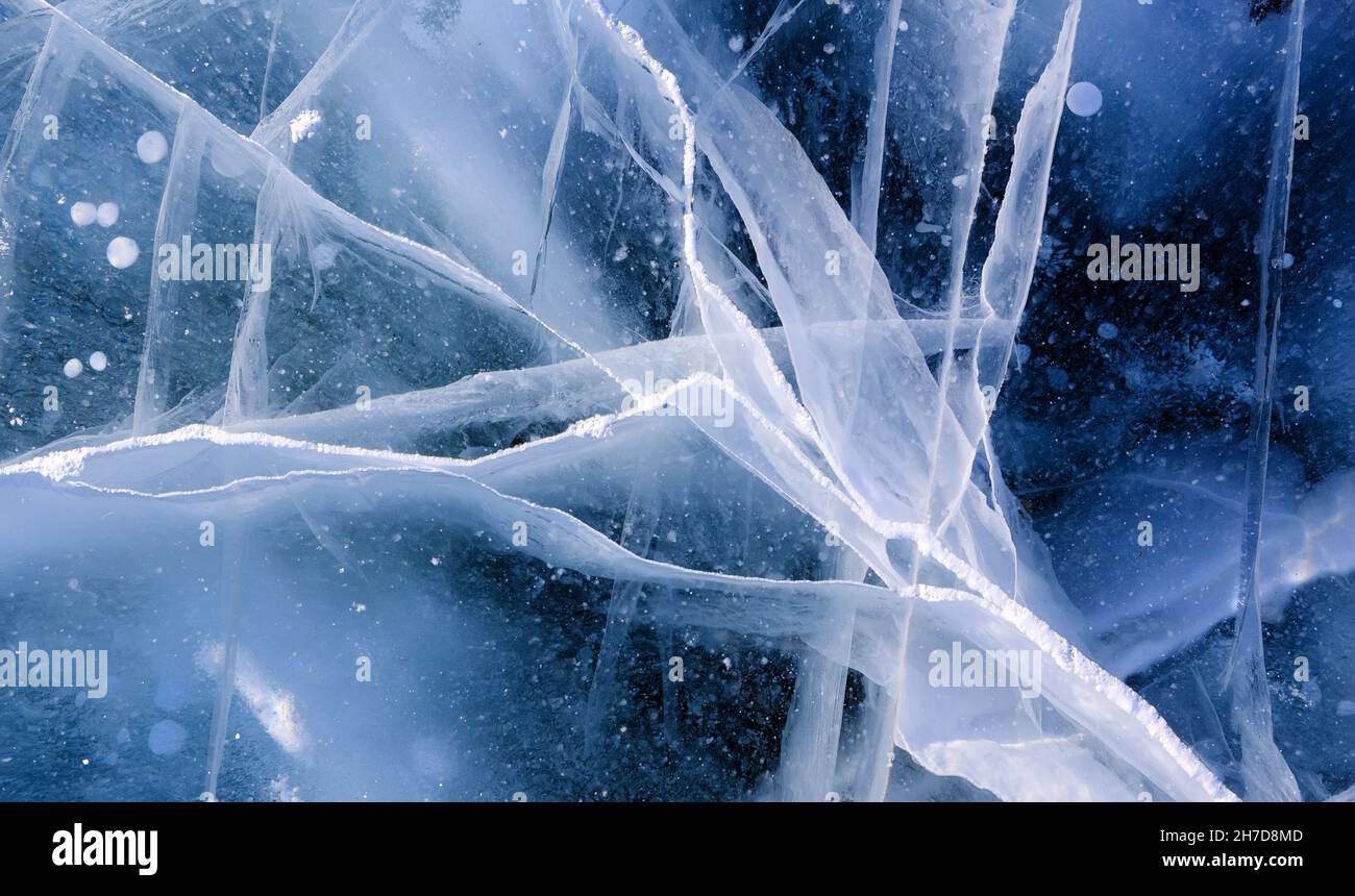 Ice surface of Baikal lake in Siberia with cracks. Natural frozen water ...