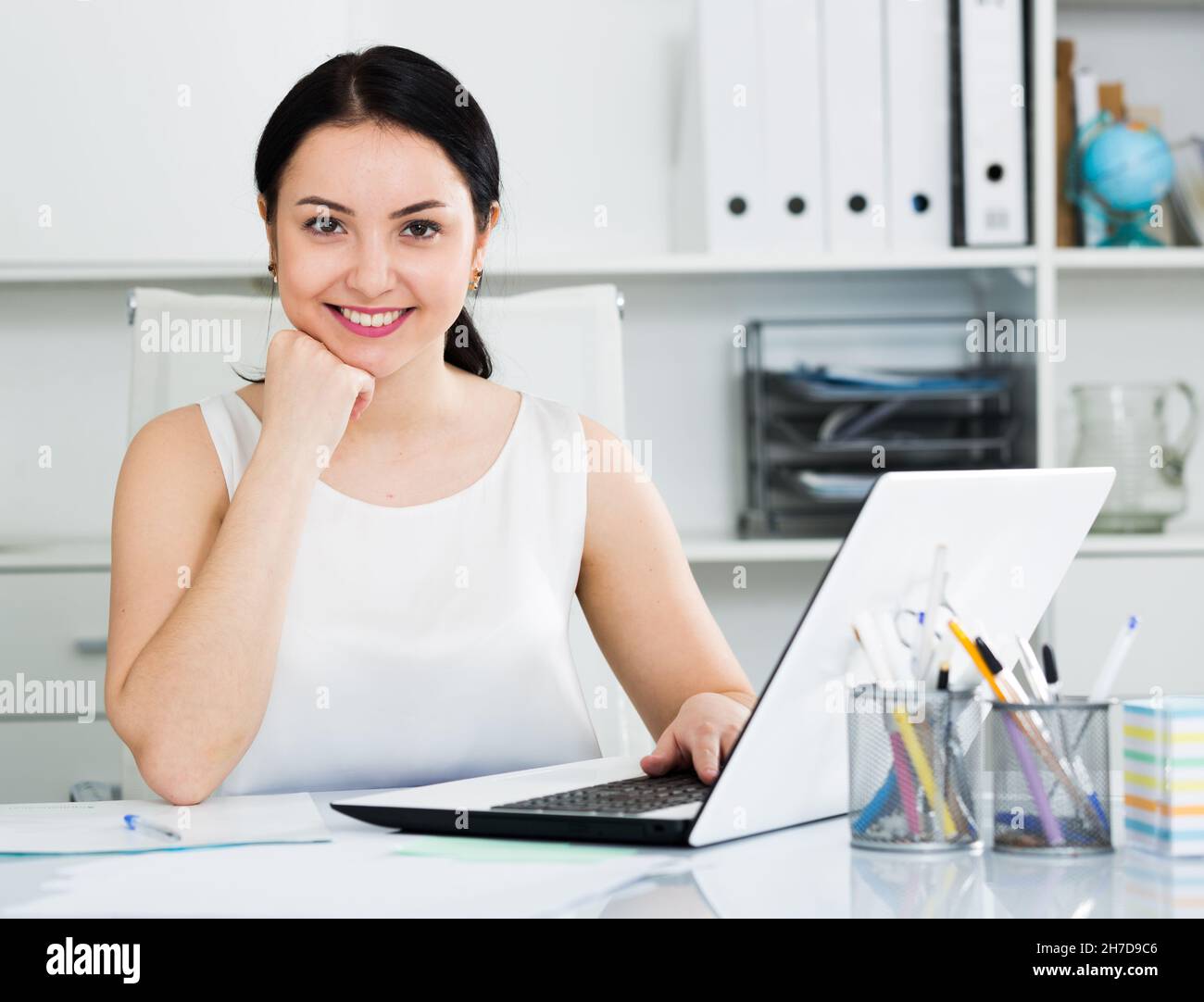 Woman posing in office Stock Photo - Alamy