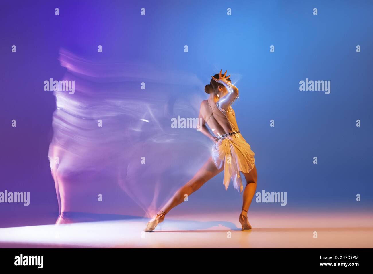 Portrait of young graceful flexible woman dancing ballroom dance ...