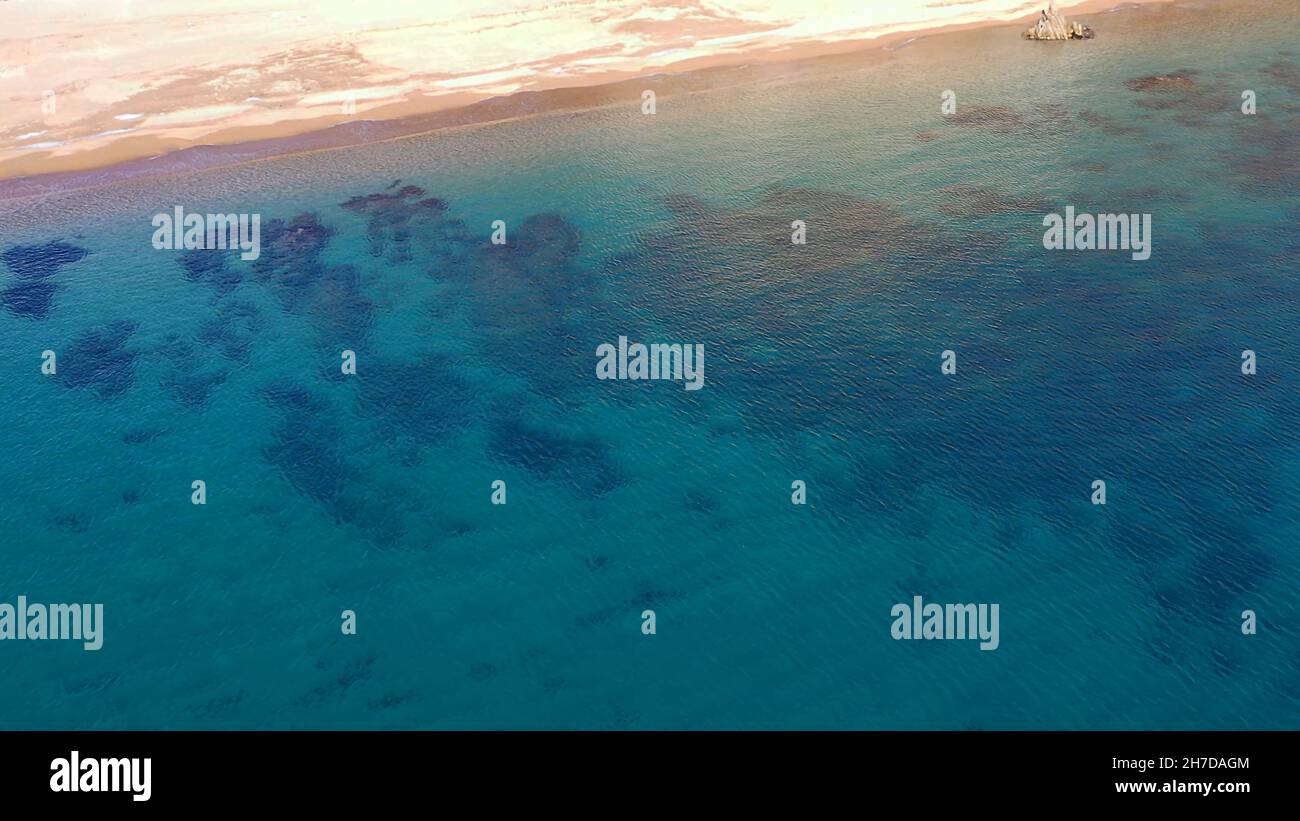 Aerial view of the ocean surface with clear water and a view of the ...