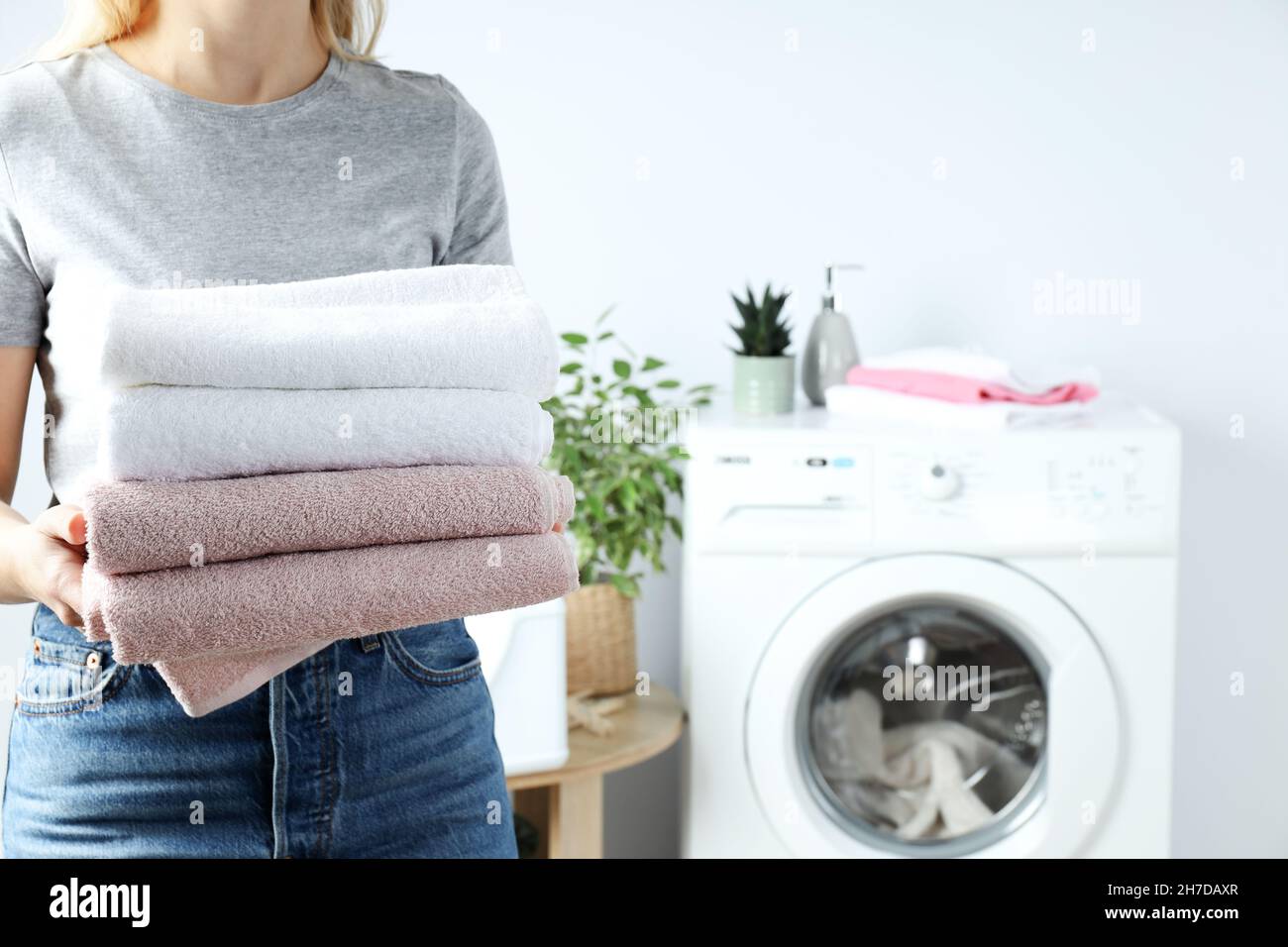 Concept of housework with washing machine and girl on white background ...