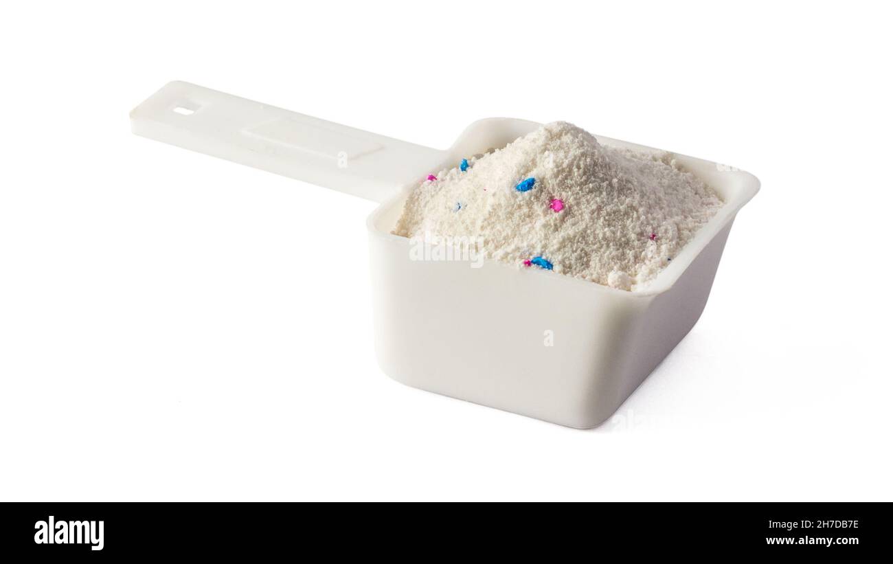 detergent powder in a measuring spoon isolated on white background ...