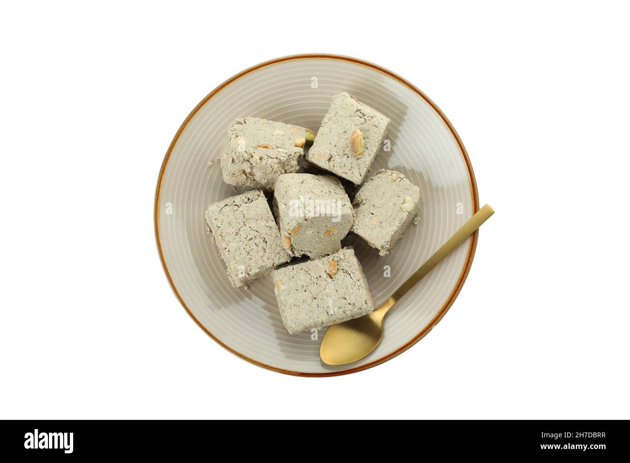 Plate with halva and spoon isolated on white background Stock Photo - Alamy