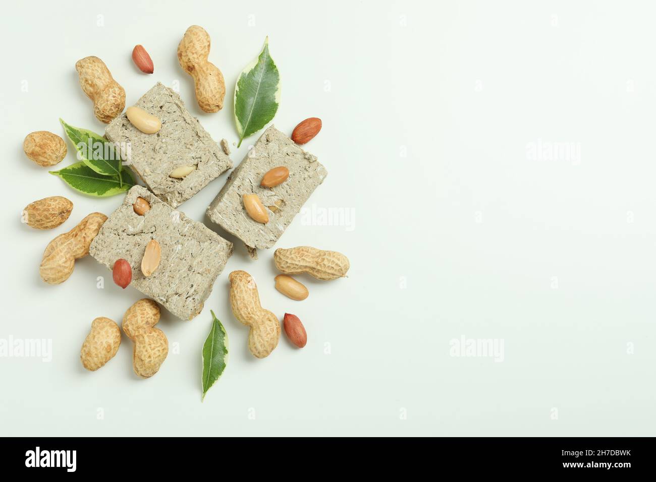 Concept of tasty food with halva and nuts on white background Stock Photo - Alamy