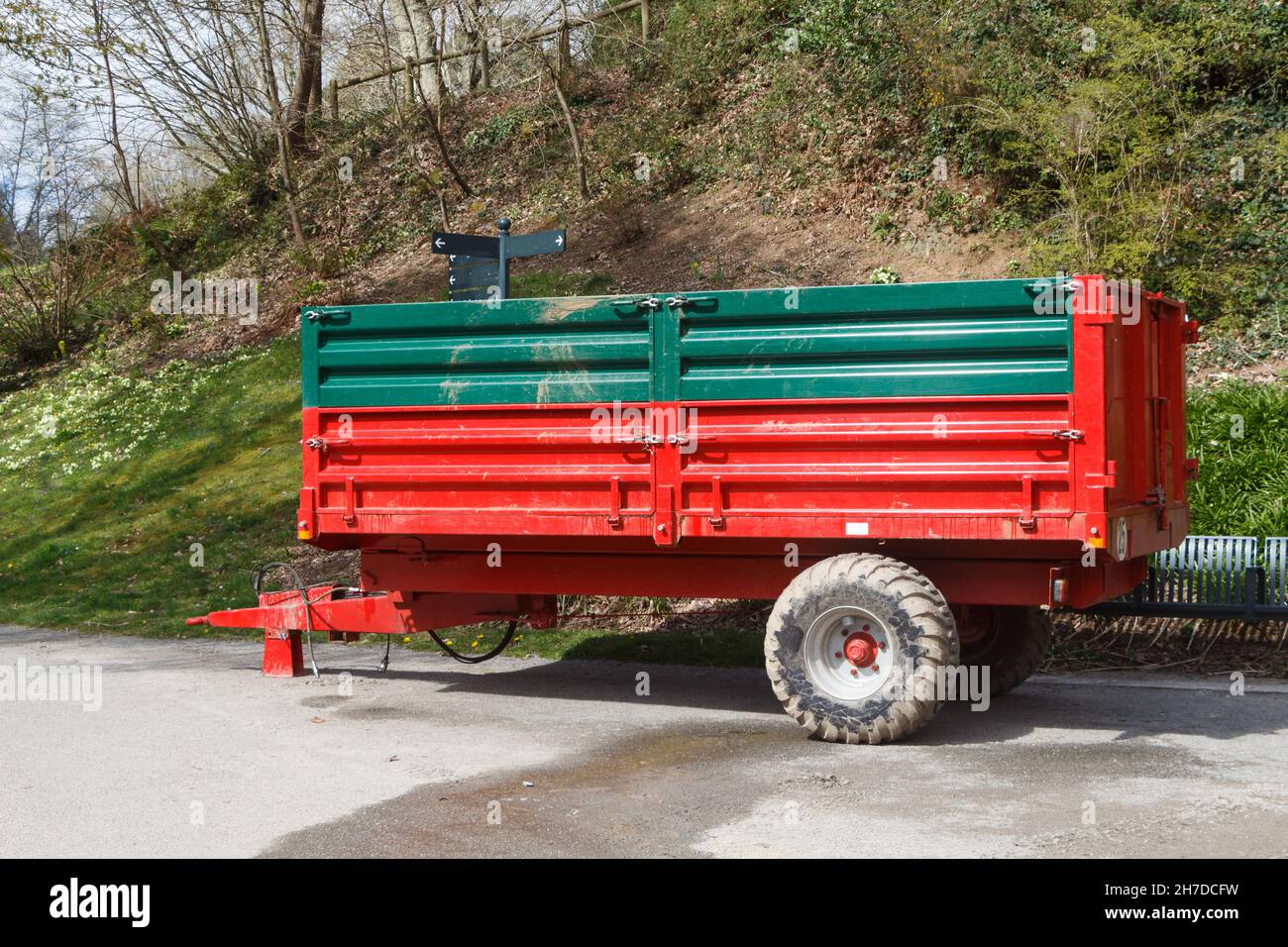 Red and green agricultural trailer in the backyard of a farm Stock ...