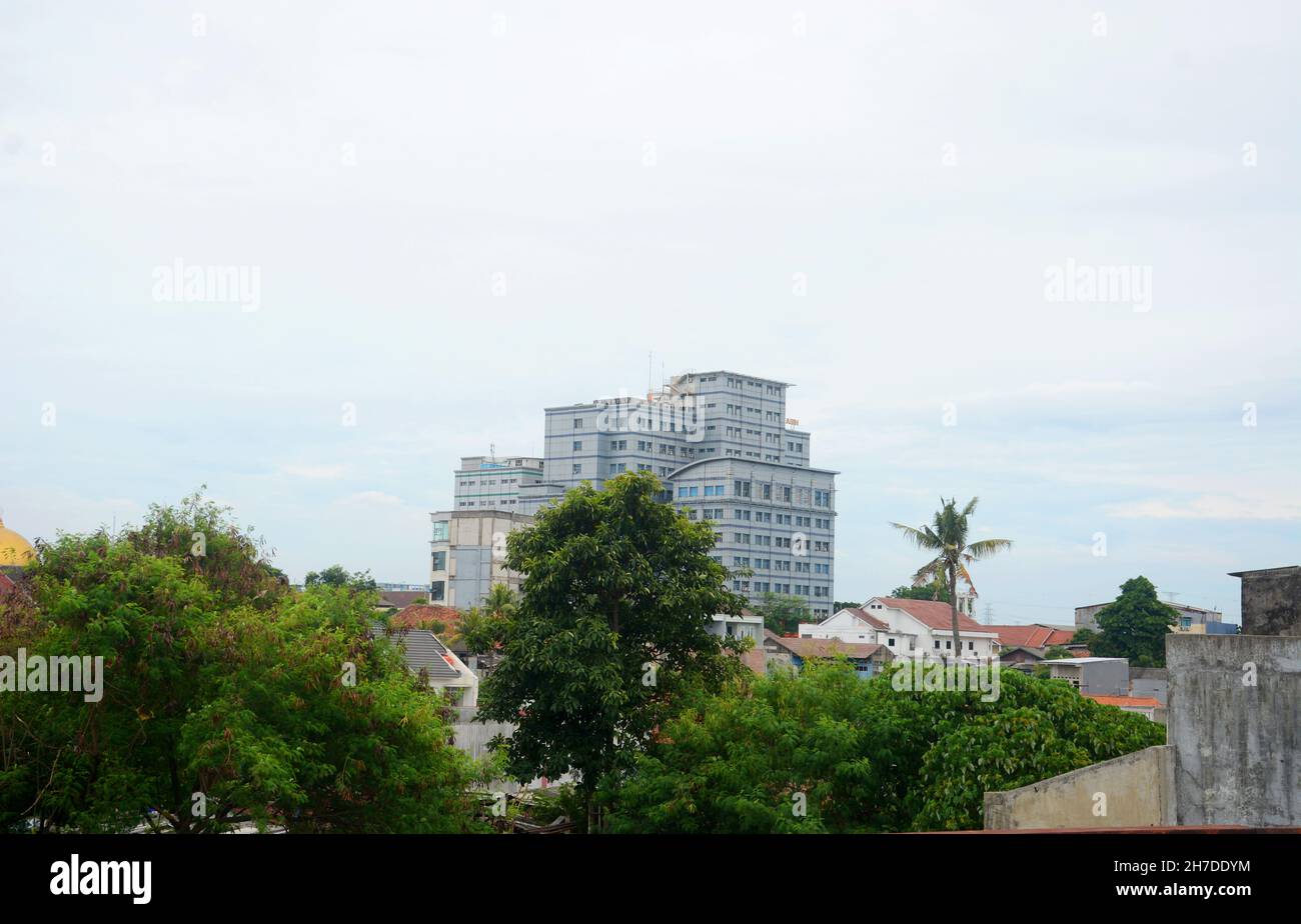 residential areas in Jakarta which are located between large buildings ...
