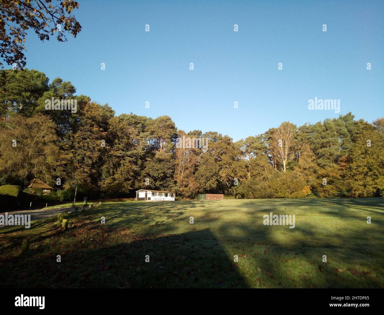 A small cricket pavilion set in a lovely wooded surrounding Stock Photo ...