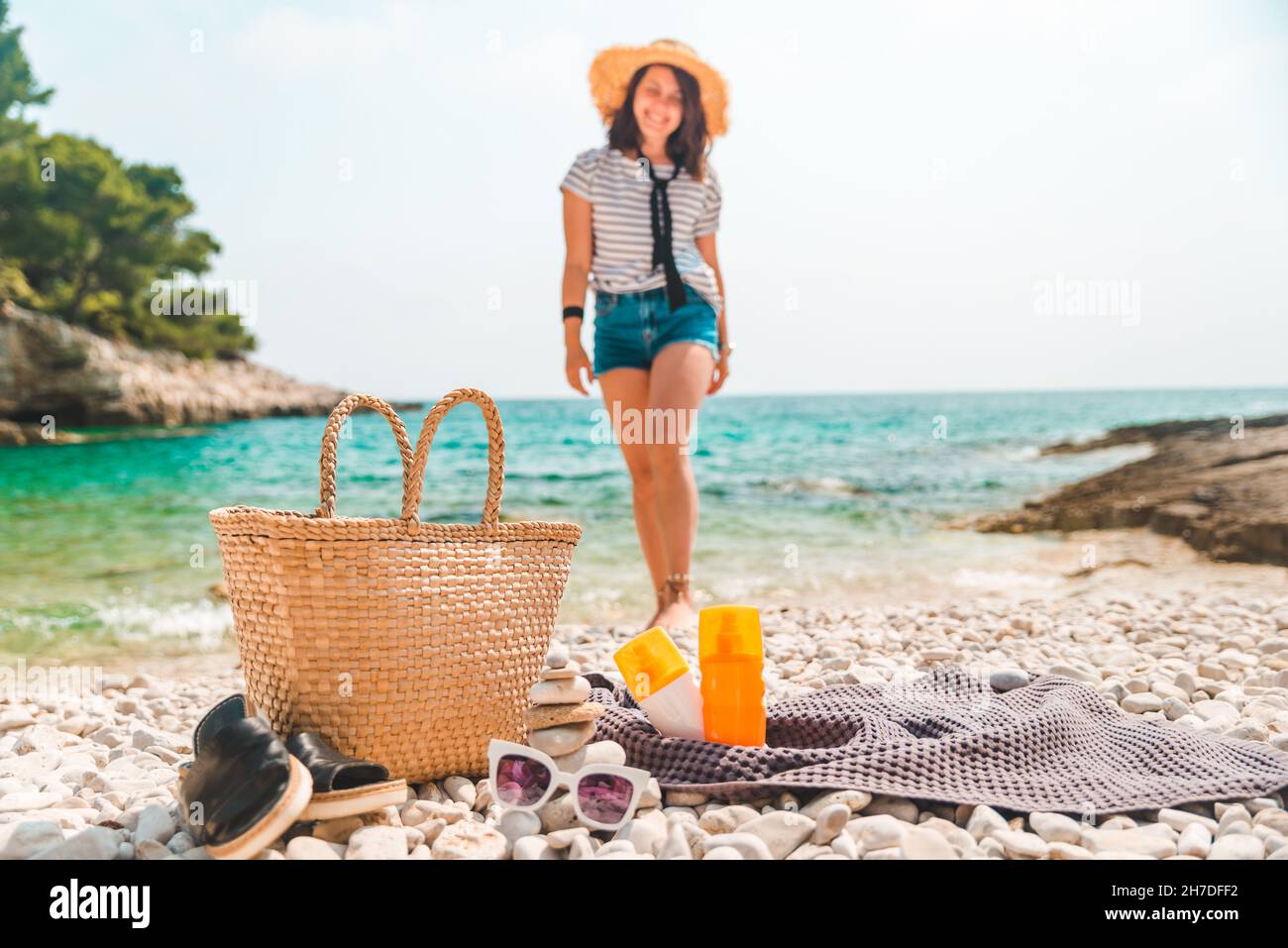 beach stuff straw hat and bag with flippers and sun protection cream at ...
