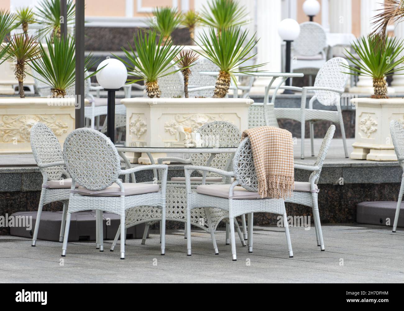 white wicker rattan furniture on the street outside the building Stock ...