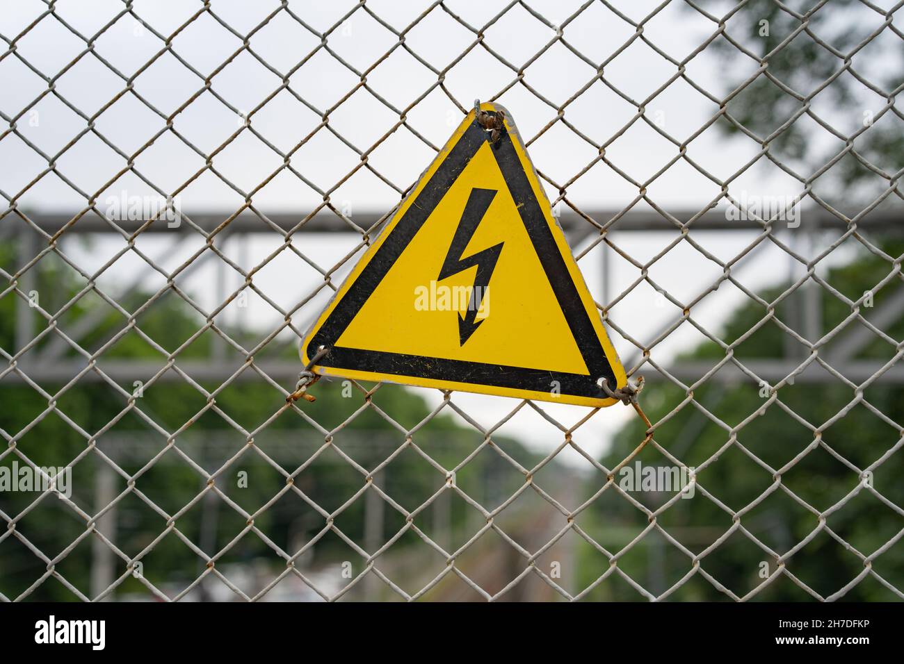 yellow triangle with black lightning on a metal mesh background Stock ...