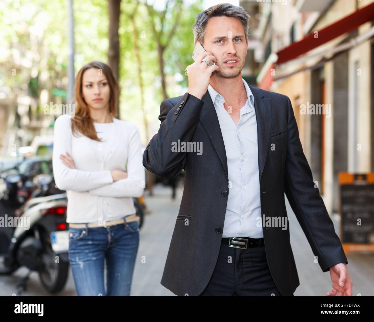 Man ignoring frustrated girl Stock Photo - Alamy