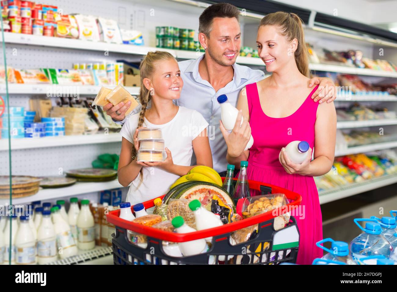 Happy family customers choosing yogurt Stock Photo - Alamy