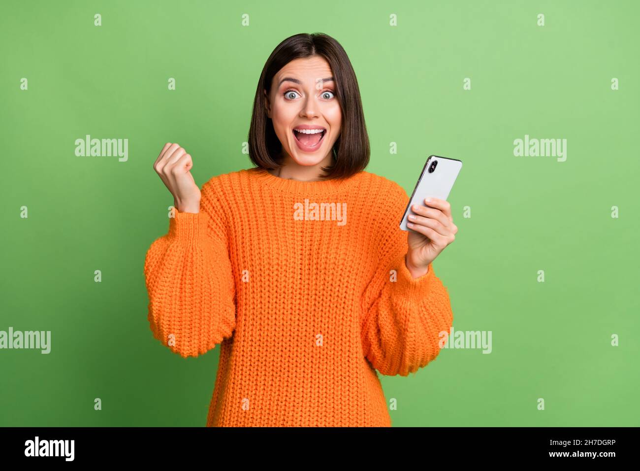 Portrait of attractive trendy cheerful girl using device rejoicing ...