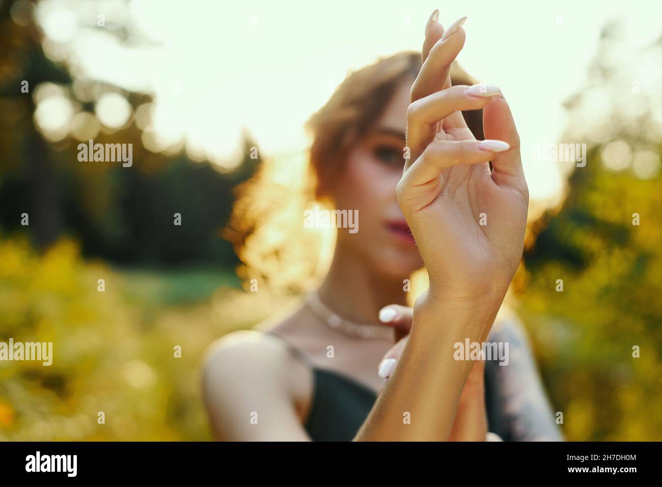 Portrait beautiful woman in forest at sunset. Woman is resting in ...
