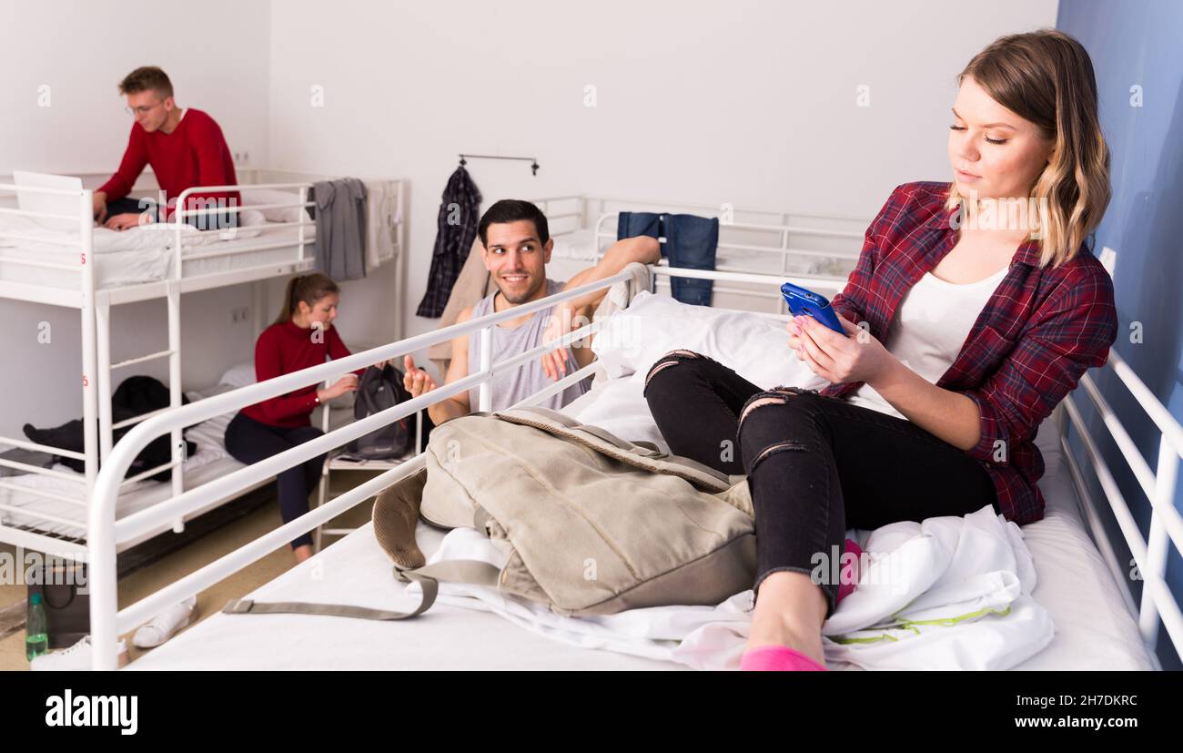 Girl ignoring neighbors in hostel Stock Photo - Alamy