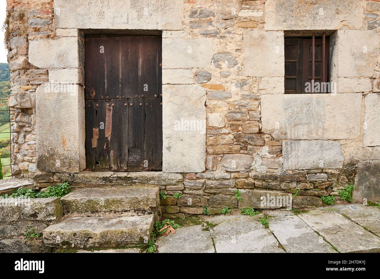 Stone wall with old entrance and wooden door Stock Photo - Alamy