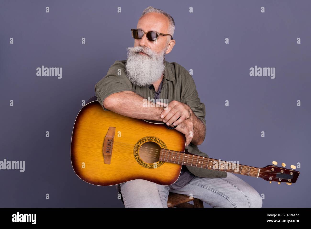 Portrait of attractive serious talented grey-haired man singer holding ...