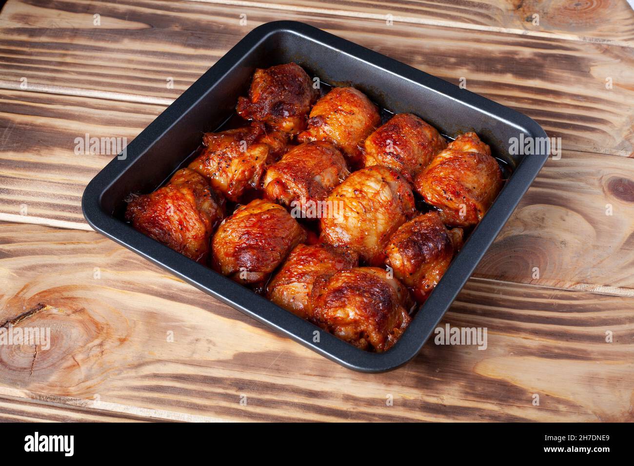 Roasted chicken thighs on baking sheet pan. Cooked Baked chicken parts ...