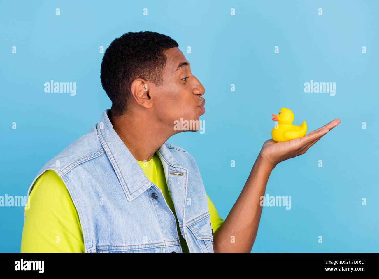Profile side photo of young african man plump lips send kiss duck ...