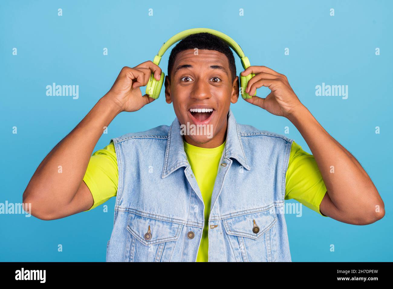 Photo of young afro guy have fun listen music earphones radio melody ...